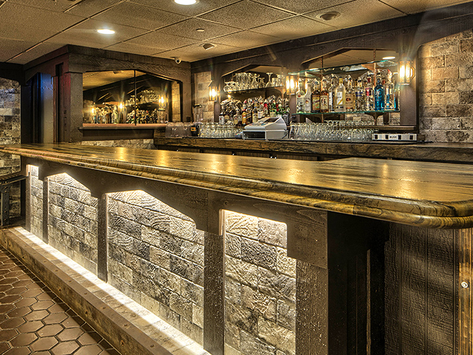 The bar isn't just where you wait for your table&mdash;it's a destination itself, with warm lighting and a stone facade that whispers "stay for one more."