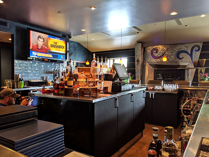 The bar: where spirits meet spirited conversation. That mosaic fireplace isn't just for show&mdash;it's warming souls and inspiring second rounds since day one.