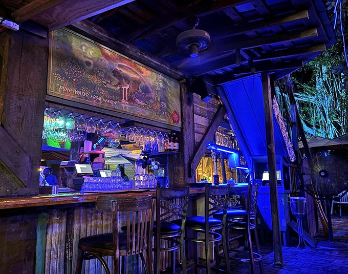 As evening falls, the bar glows with blue light, transforming from casual eatery to the kind of place where Jimmy Buffett songs suddenly make perfect sense.