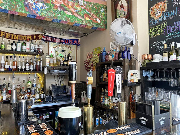 The bar area boasts an impressive selection of spirits beneath colorful soccer scarves – because proper pie demands proper libations.