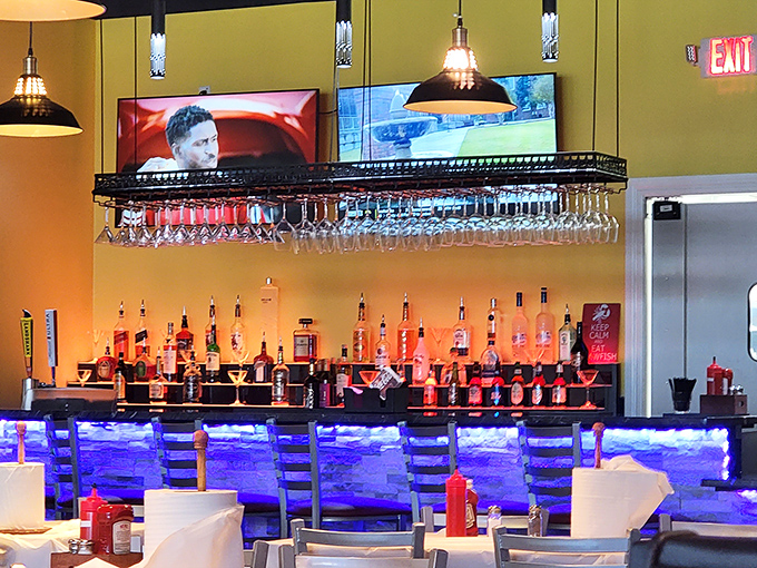 The bar glows blue like the ocean depths, promising libations that complement rather than compete with the seafood stars.