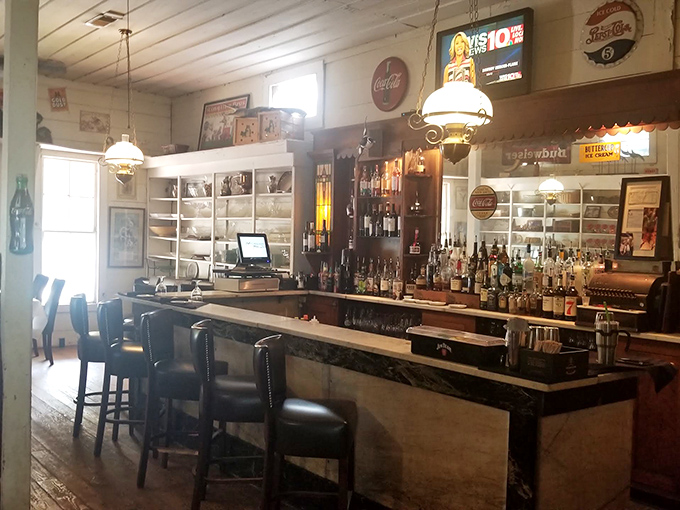 A bar that balances nostalgia with craftsmanship. Vintage signs watch over modern mixology in this inviting watering hole.