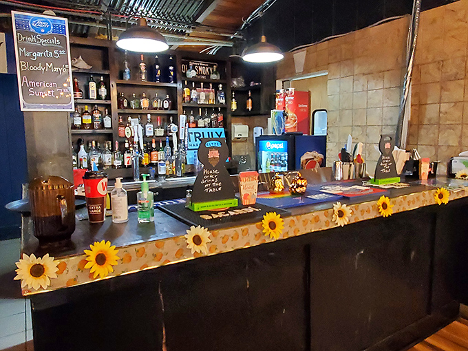 The bar area, decorated with cheerful sunflowers, serves up vacation vibes alongside those colorful cocktails. Liquid courage before tackling the crab legs.