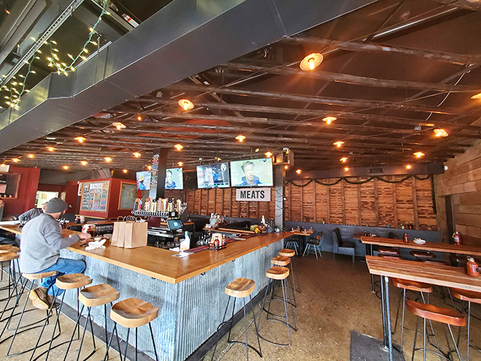 The bar area&mdash;where meat meets mingle. Industrial chic meets BBQ geek in this perfectly crafted corner of carnivore heaven.