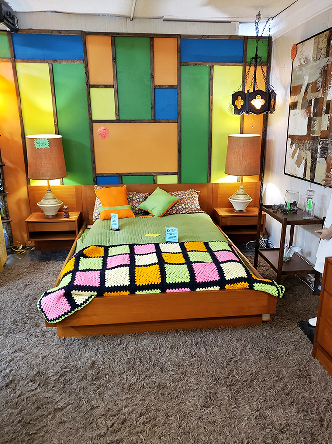 A bedroom display that's pure retro joy with stained glass headboard and matching nightstands. The 1970s called&mdash;they're jealous you found this first!
