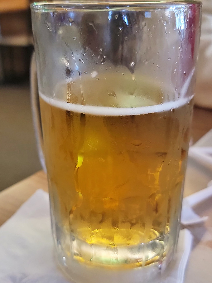 A cold beer – pizza's perfect companion since time immemorial, offering that refreshing counterpoint to the warm, cheesy goodness on your plate.