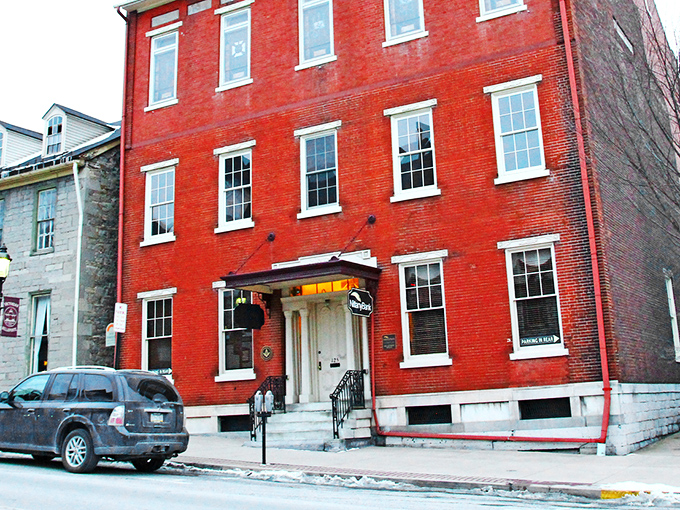 This vibrant red building doesn't just house businesses&mdash;it anchors the street with the kind of architectural confidence they don't make anymore.