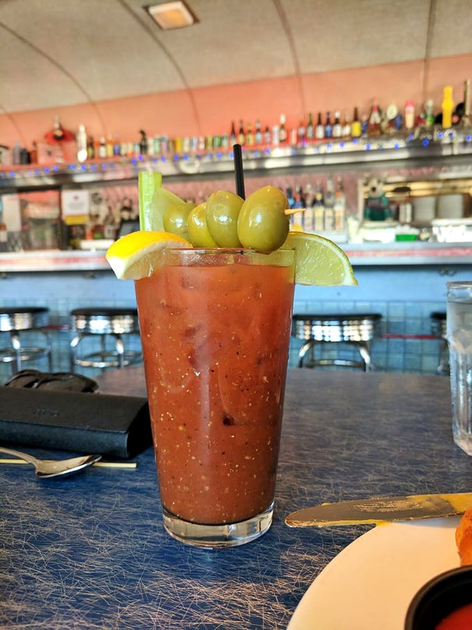 This Bloody Mary isn't just a drink, it's a garden party in a glass, complete with olives standing at attention like tiny green soldiers.