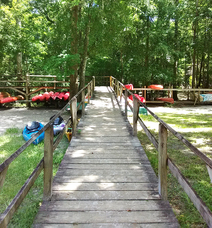 This wooden pathway leads to aquatic bliss. The red tubes aren't emergency equipment&mdash;they're your tickets to lazy river heaven.