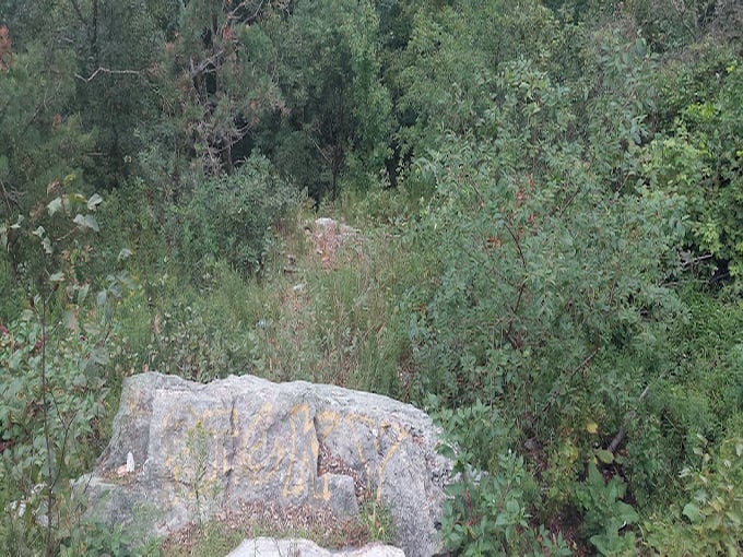 Ancient boulders stand guard, weathered witnesses to millions of years of geological drama.