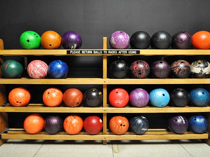 A rainbow arsenal of bowling weaponry awaits your selection. Choose wisely—your entire game depends on finding that perfect sphere-to-finger relationship.