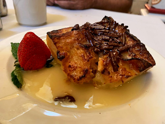 Bread pudding that transforms humble ingredients into dessert royalty, topped with chocolate sprinkles like a crown for this sweet monarch.