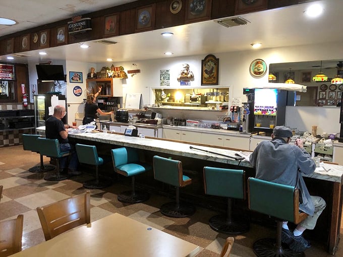 The turquoise counter stools invite solo diners to perch and watch the breakfast ballet unfold—front-row seats to culinary theater.