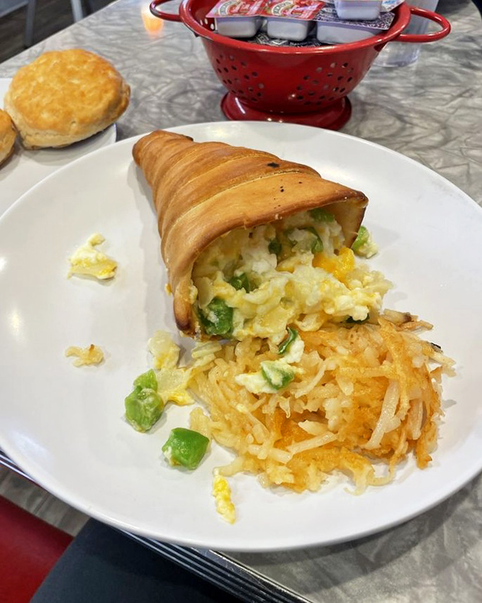 The breakfast cone—proof that innovation still exists in diner food. Eggs and hash browns nestled in a pastry cone is morning genius.