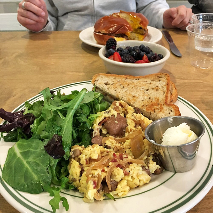 A scramble that tells a story with every bite. Fresh greens and toast on the side for the supporting characters.