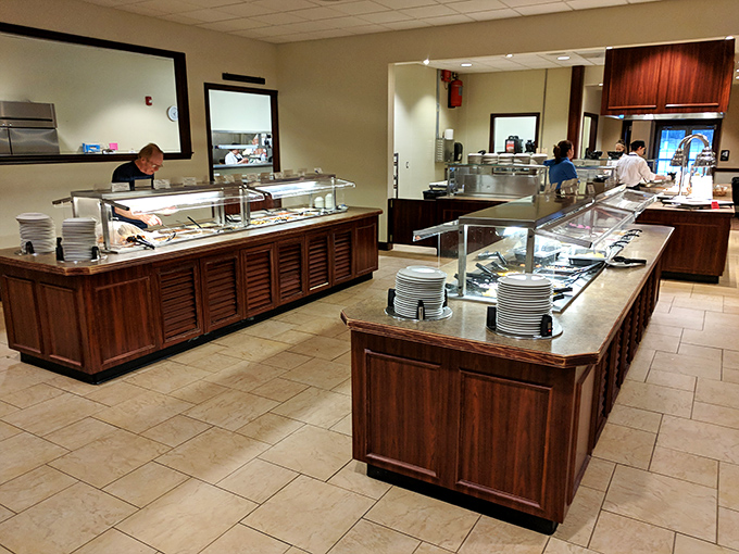 The buffet stations stand at attention, ready for the lunch rush with their gleaming surfaces and promise of abundance.