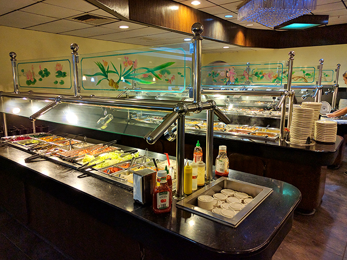 Behind the glass shields, a parade of dishes waits patiently, like contestants in a beauty pageant where everyone's a winner.