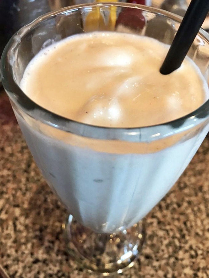 This butterscotch shake looks thick enough to require serious straw commitment—the kind that makes your cheeks hurt in the best possible way.