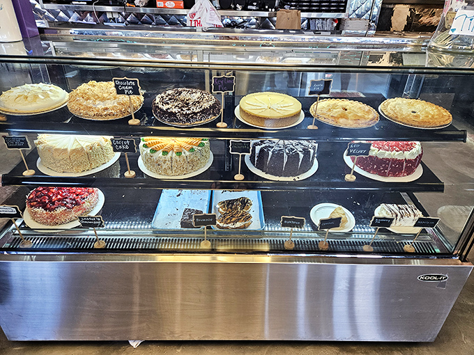 A cake display that should come with a warning label: "May cause spontaneous drooling and the sudden need to celebrate unbirthdays."