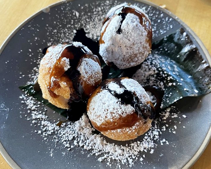 These golden carioca balls dusted with powdered sugar aren't just dessert—they're little spheres of joy that would make your dentist nervous.