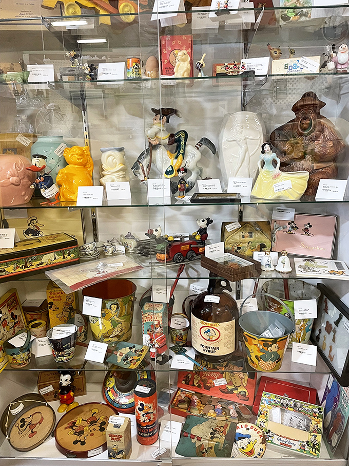 Disney collectibles behind glass&mdash;where childhood memories meet adult collecting budgets. That Mickey tin might be worth more than your first car.