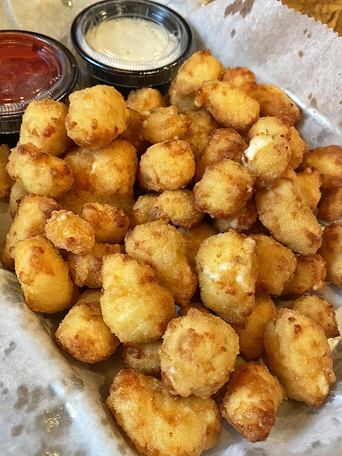 Cheese curds: Wisconsin's gift to humanity. These golden nuggets squeak between your teeth like tiny dairy protestors refusing to go quietly.