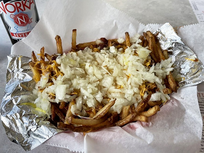 Chili cheese fries arrive as a mountainous masterpiece, proving some indulgences are worth every glorious calorie.