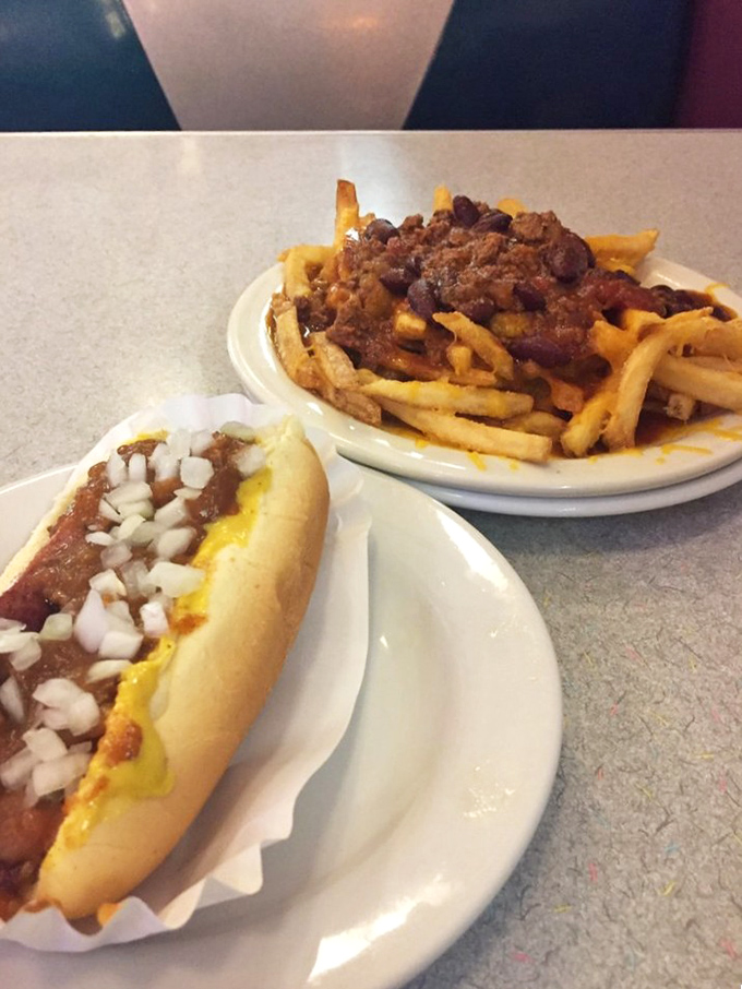 The dynamic duo of diner perfection &ndash; a classic coney dog alongside fries smothered in that legendary meat sauce.