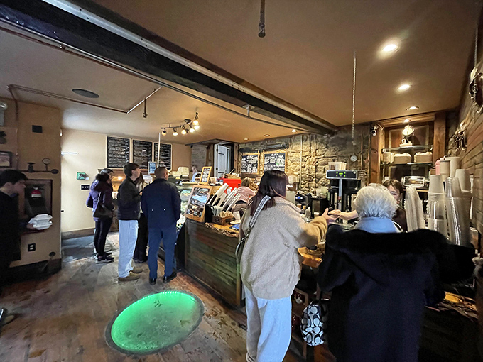 The line forms at the counter where dreams are dispensed one pastry at a time. That circular cutout in the floor adds mystery&mdash;perhaps it's where they hide the secret recipes.