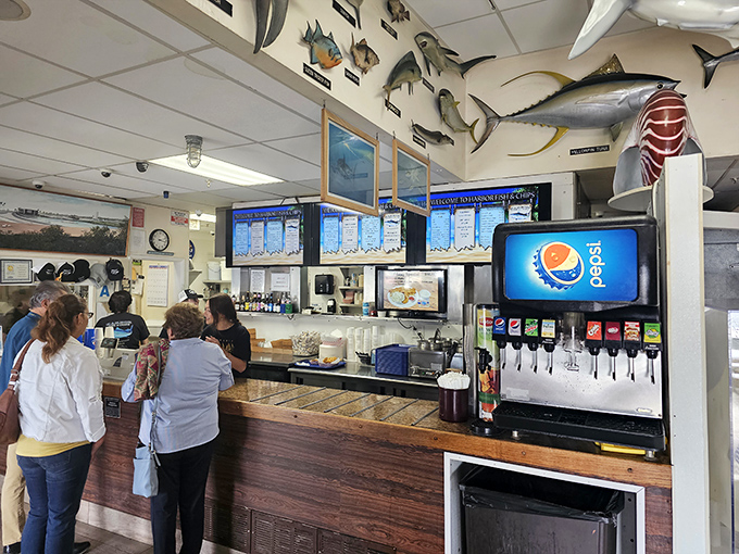 At the counter, where decisions are made and appetites are about to be satisfied, beneath a ceiling of seafaring souvenirs.