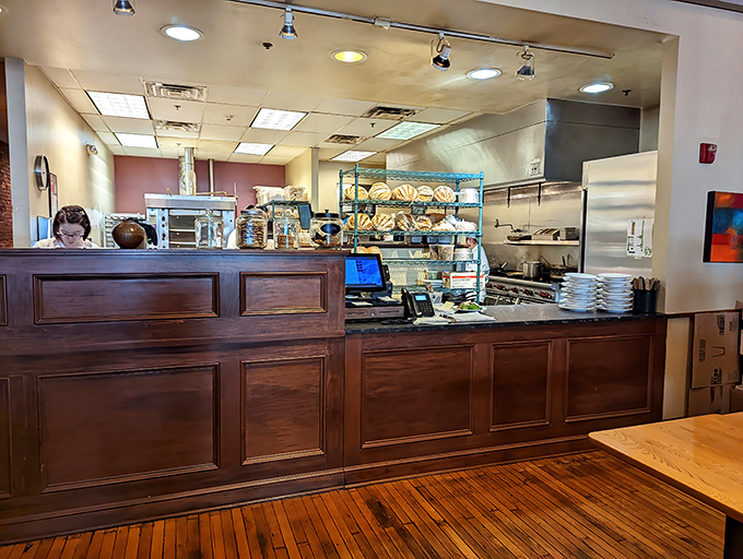Behind this counter, bread dreams come true. Those loaves are the reason buttons pop and diets fail spectacularly. 