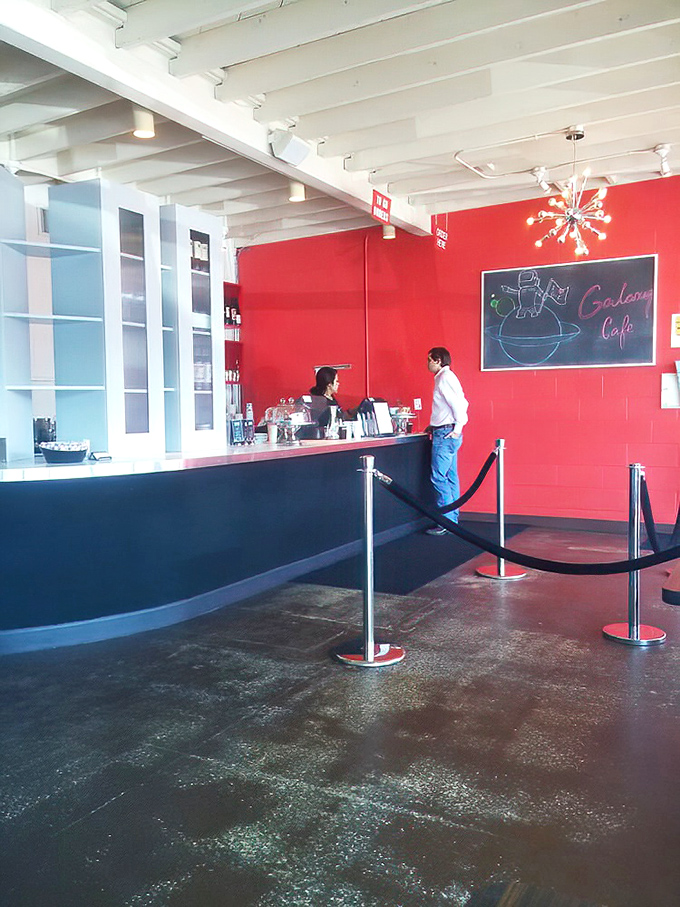The ordering counter where breakfast dreams begin. That red wall and chalkboard menu scream "we're casual but we care." 