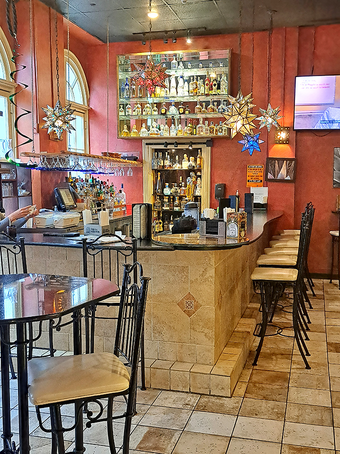 The bar area promises liquid happiness with its impressive tequila collection&mdash;each bottle a potential story waiting to be poured.