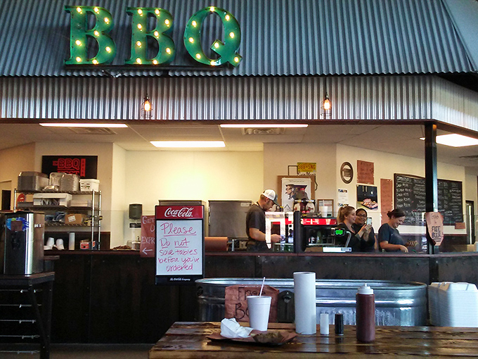 The illuminated BBQ sign glows like a North Star for meat lovers, guiding hungry travelers to the promised land of perfectly smoked proteins.