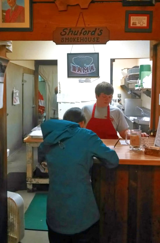 The ordering counter, where barbecue dreams begin. That "BAMA" sign might raise eyebrows in Tennessee, but great barbecue transcends rivalries.