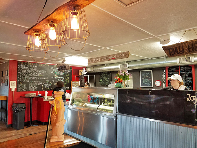 The counter where barbecue dreams come true. That sign reading "We don't serve mean people" sets the perfect tone for this smoke-scented sanctuary.