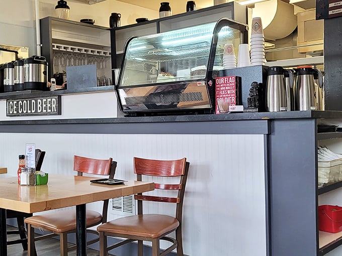 The counter view: where coffee thermoses stand at attention and pastry cases tempt you into dessert-for-breakfast decisions.