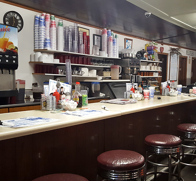 The counter where regulars perch like birds on a wire, exchanging news and watching the diner ballet unfold.