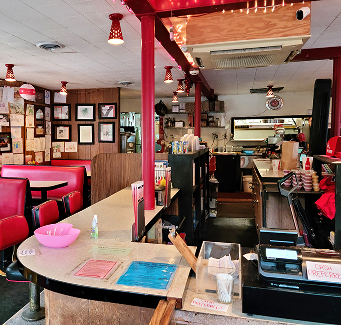 The command center of comfort food, where burgers are born and milkshakes materialize under the watchful gaze of those festive red ceiling lights.
