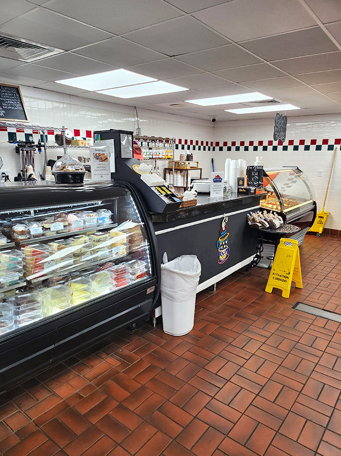 The dessert counter—where willpower goes to die and happiness begins. Those display cases are basically glass-fronted joy factories.