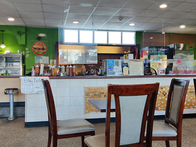 Where the magic happens—a glimpse behind the counter. That burger sign hints at land options, but the seafood is what keeps the regulars coming back.