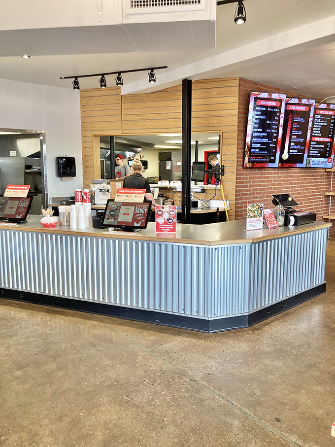 The corrugated metal counter gleams with promise. Behind it, chicken dreams become reality through a well-choreographed culinary dance.