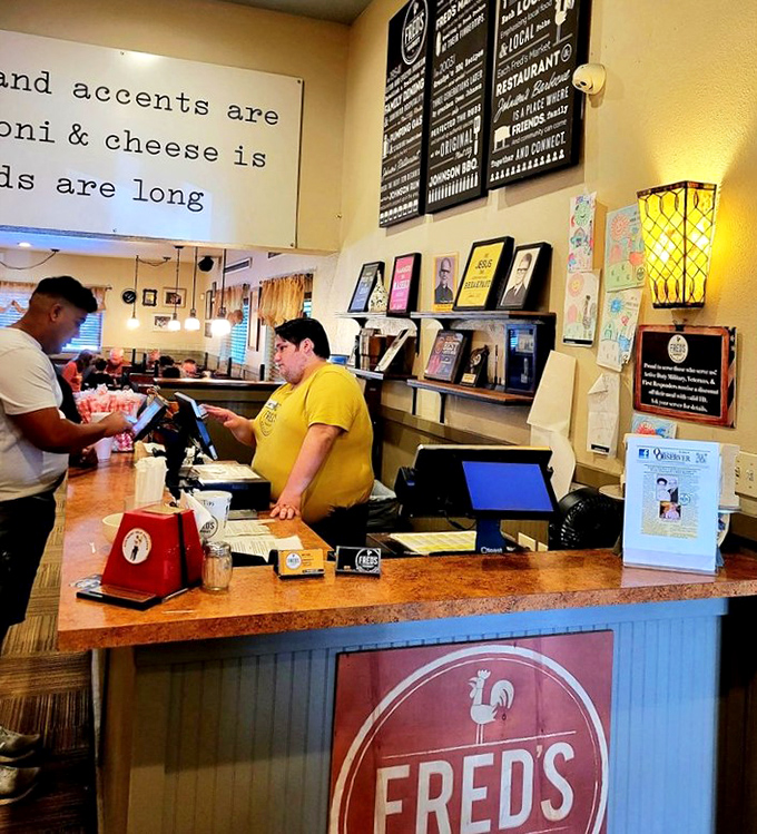 The counter where magic begins: friendly faces, rooster logos, and the promise of Southern hospitality before you even reach your table.