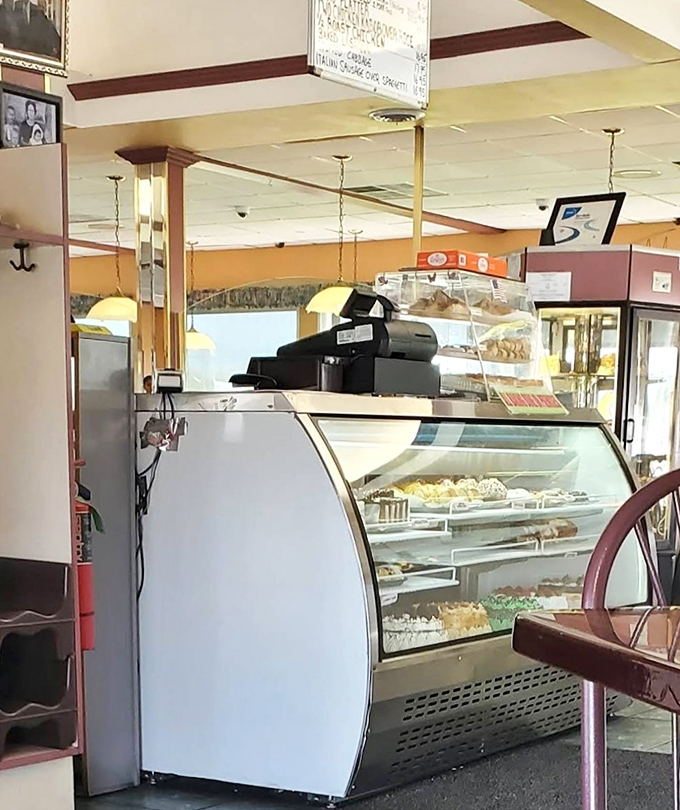 The dessert case&mdash;where willpower goes to die. Those pastries and cakes aren't just displayed; they're performing a siren song visible from every booth.