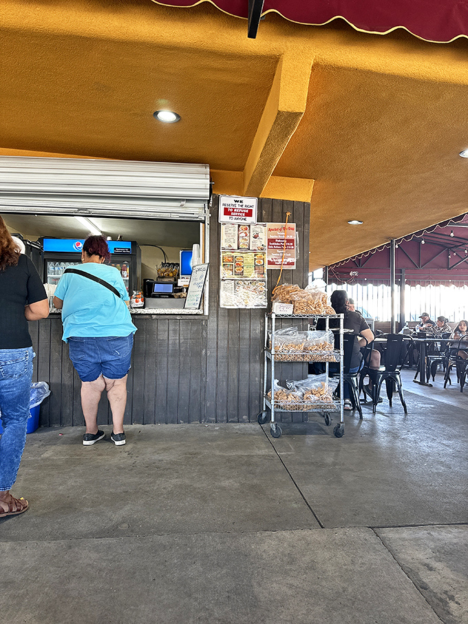 The ordering counter buzzes with activity as staff efficiently serve up authentic Mexican comfort food to eager customers.
