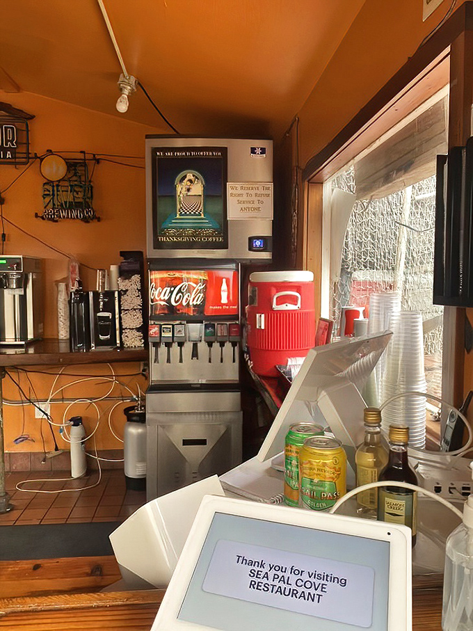 Inside the tiny kitchen where big flavors are born. That orange glow isn't just lighting &ndash; it's the warm welcome that makes every visitor feel at home.