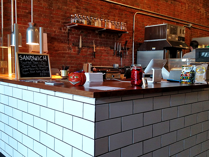 The white-tiled counter where sandwich dreams become reality – minimalist design that says "we're focusing all our attention on what matters: your lunch."