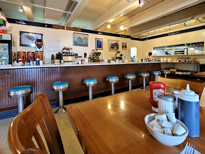 The counter where regulars perch, trading stories over coffee while watching the breakfast ballet unfold in the kitchen.