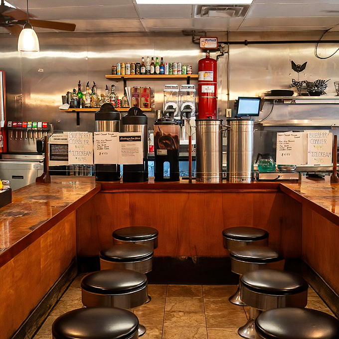 Bar seating that invites lingering over coffee refills. The worn wooden counter holds the invisible fingerprints of thousands of satisfied customers.