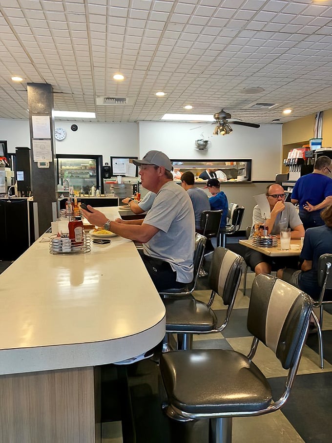 Counter seats: the front-row tickets to breakfast theater, where regulars perform the daily ritual of newspaper reading and coffee sipping with practiced precision.